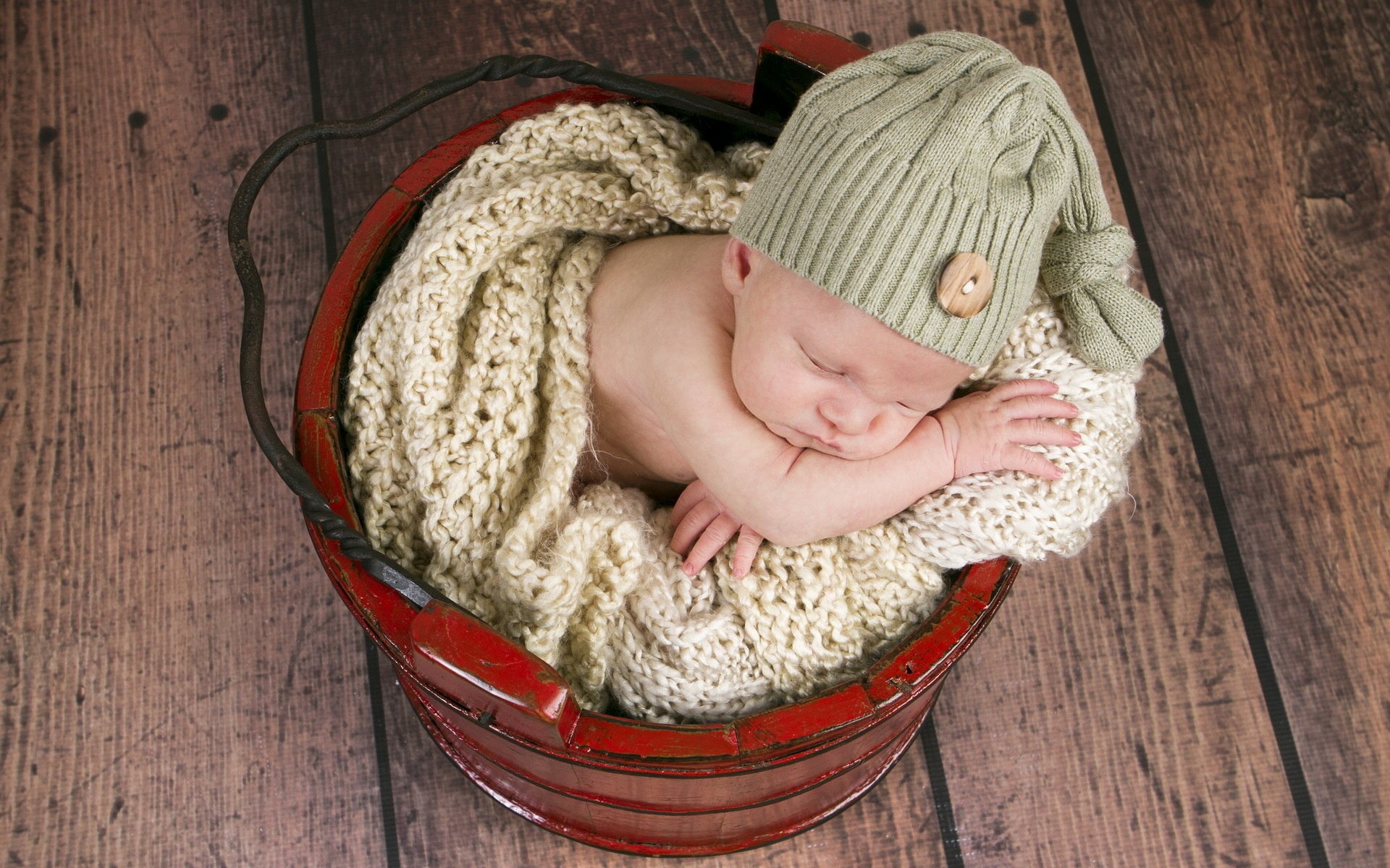 HD Wallpaper of a Sleeping Child in a Cozy Basket