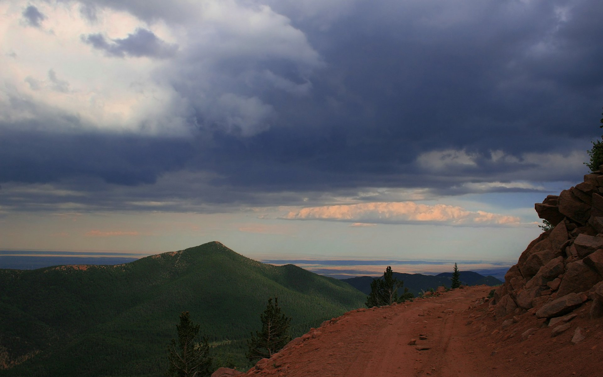 Mountain Trail Dust: Stunning HD Landscape Under Dramatic Sky