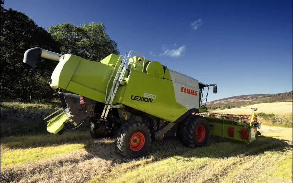 Claas Axion 990 Tractor: HD Wallpaper in a Dramatic Field Landscape