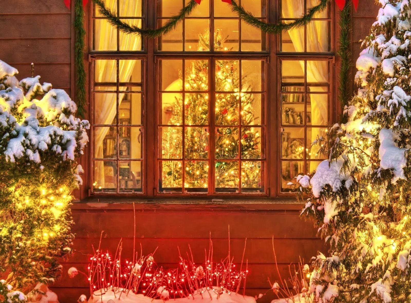 Cozy Christmas Glow: Snowy Holiday Window with Festive Tree and Lights