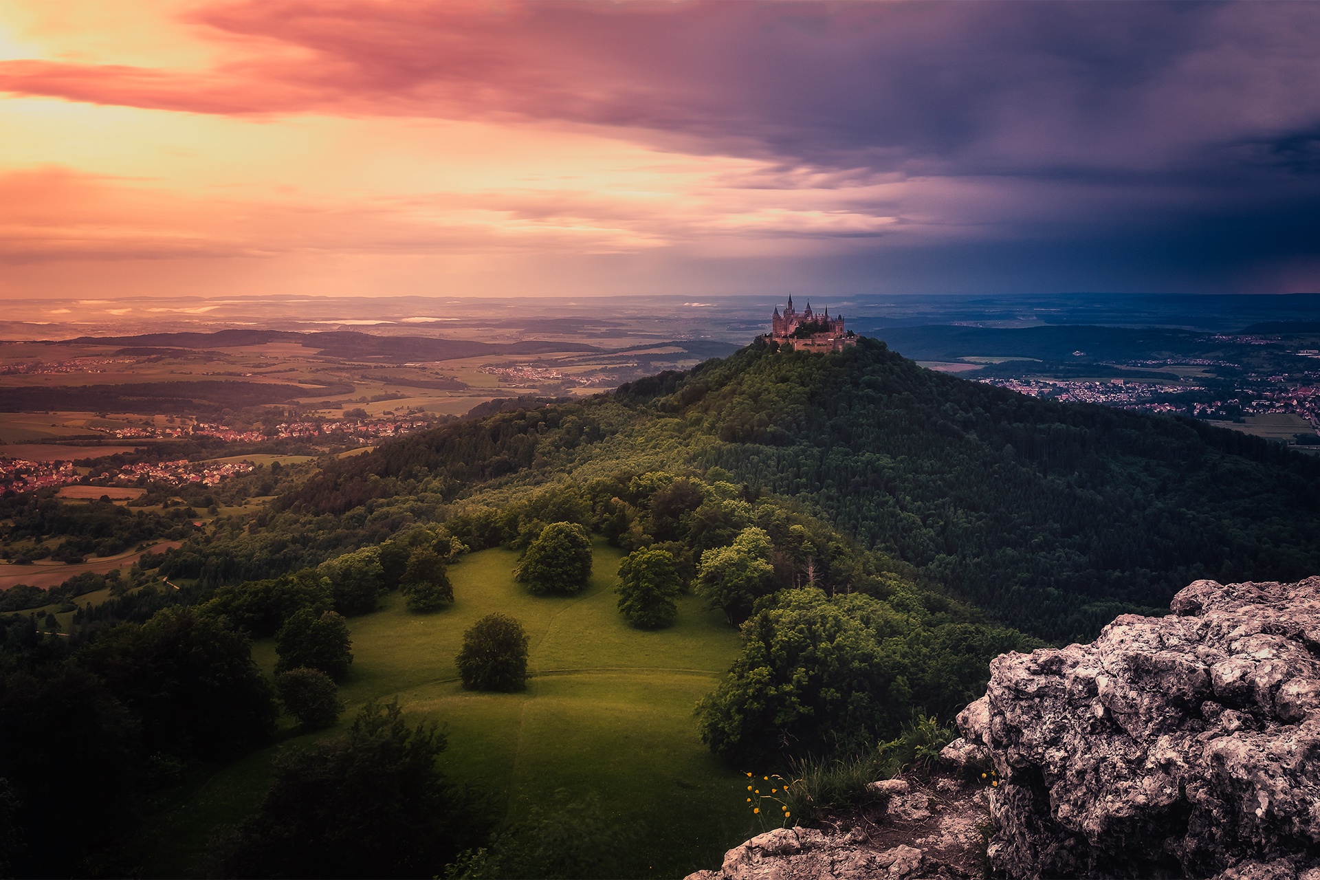 Majestic German Castle Overlooking Forested Hills at Sunset Panorama