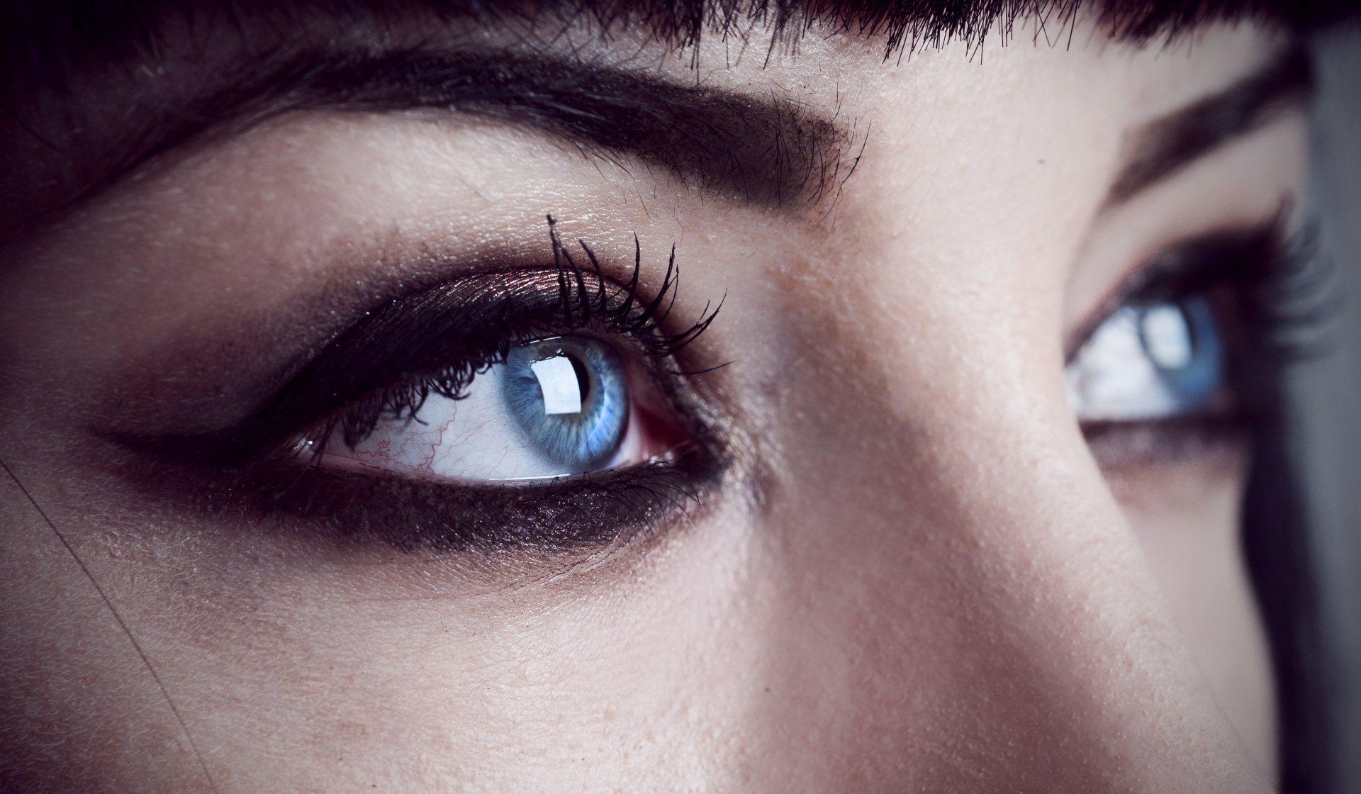 Mesmerizing Blue Eyes: HD Close-Up of a Woman's Gaze