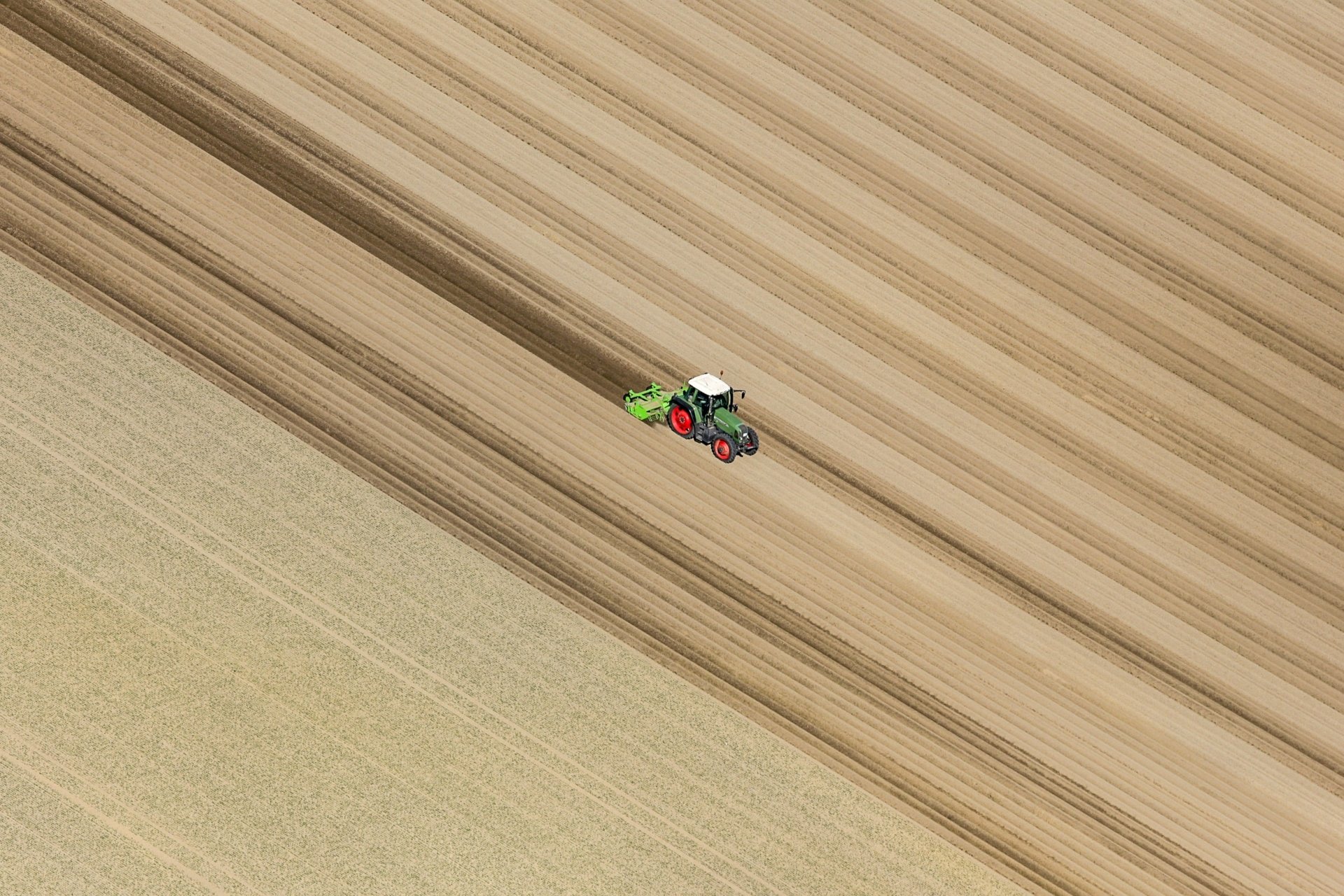 HD Aerial View of Tractor Working Across Expansive Field – Stunning ...