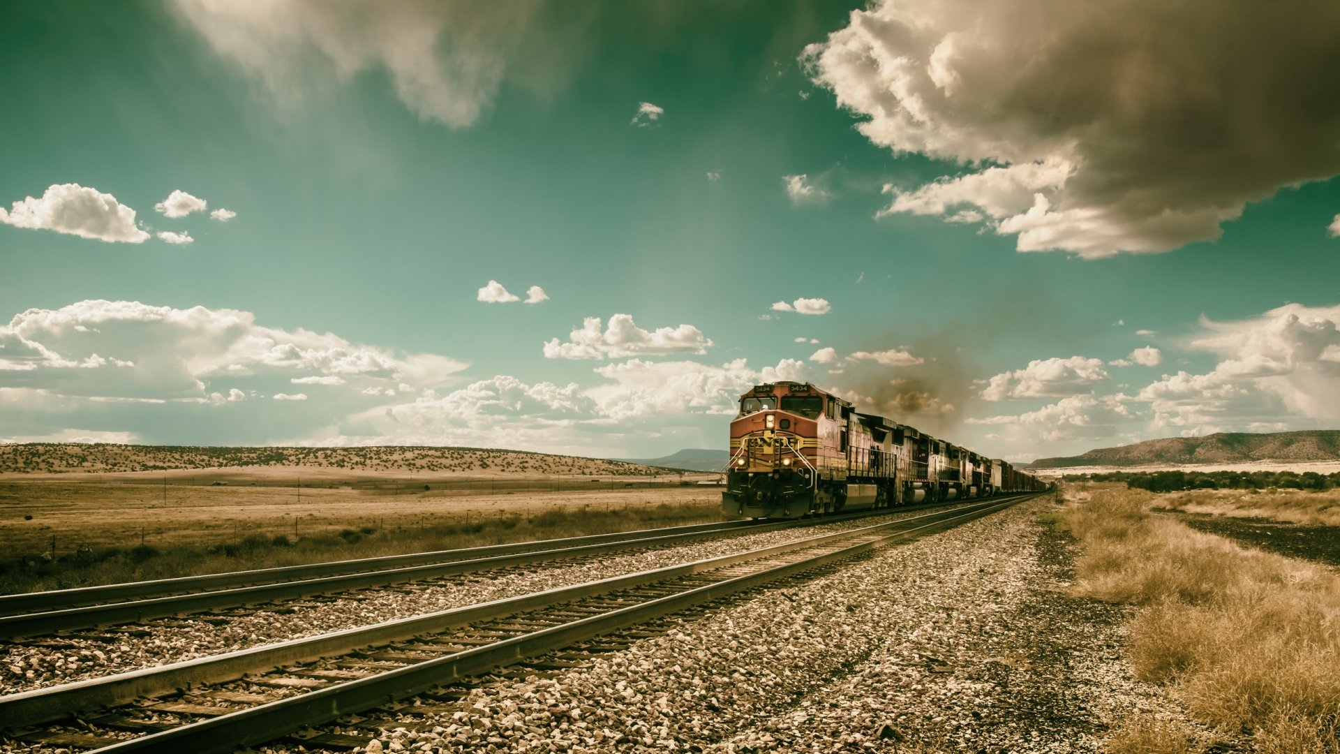 HD Scenic Train Journey Under Expansive Sky and Clouds